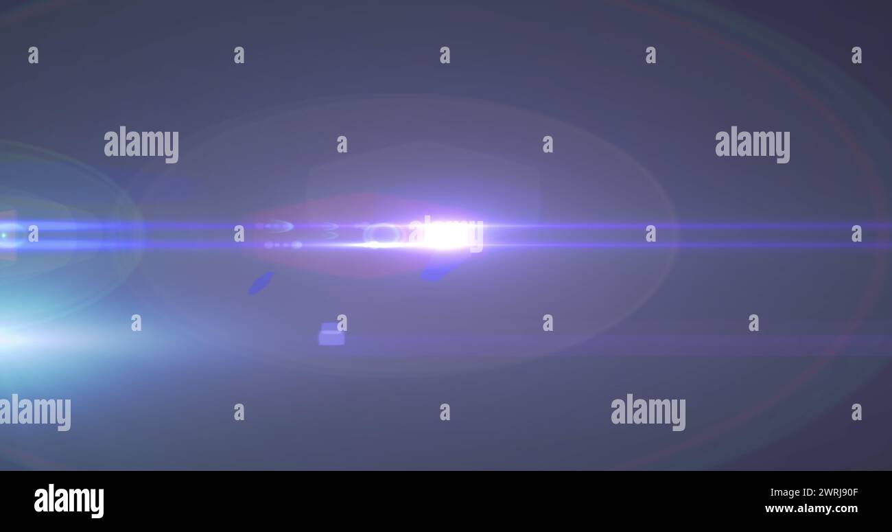 Image of spotlight with lens flare and light beams moving over dark ...