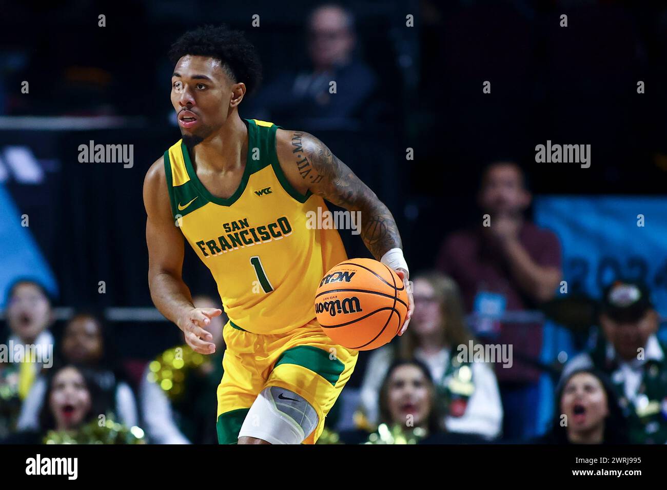 San Francisco guard Malik Thomas takes the ball up the court during the ...