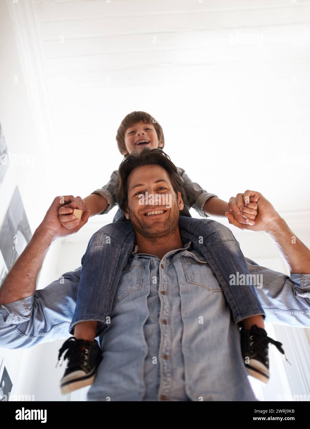 Piggyback, portrait or father with child in home, house or apartment ...