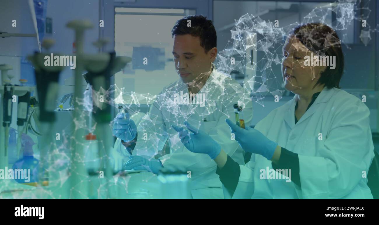 Image of rotating DNA strand over scientists wearing lab coats working ...