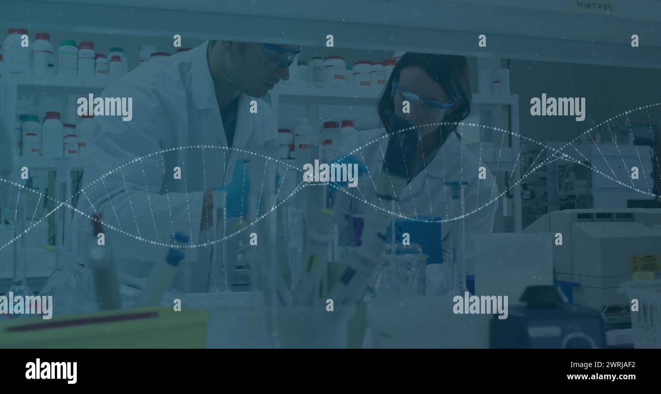 Image of rotating DNA strand over scientists wearing lab coats working ...