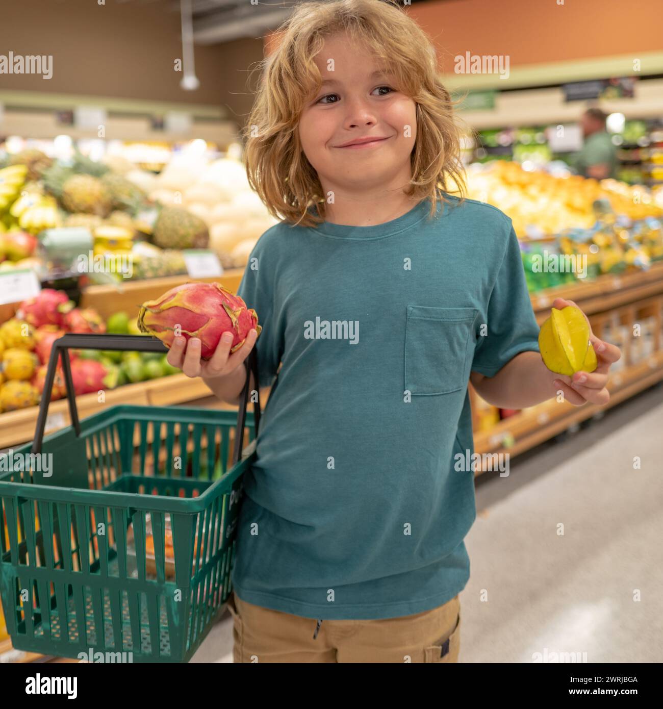 Kid with fruits. Little child choosing food in grocery store or a ...