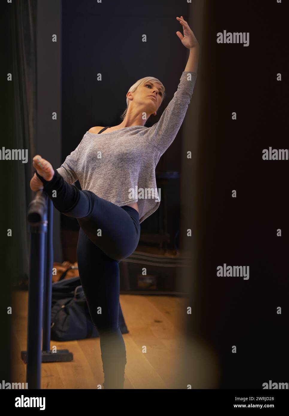 Ballet, posture and woman with leg stretch in dance studio for ...