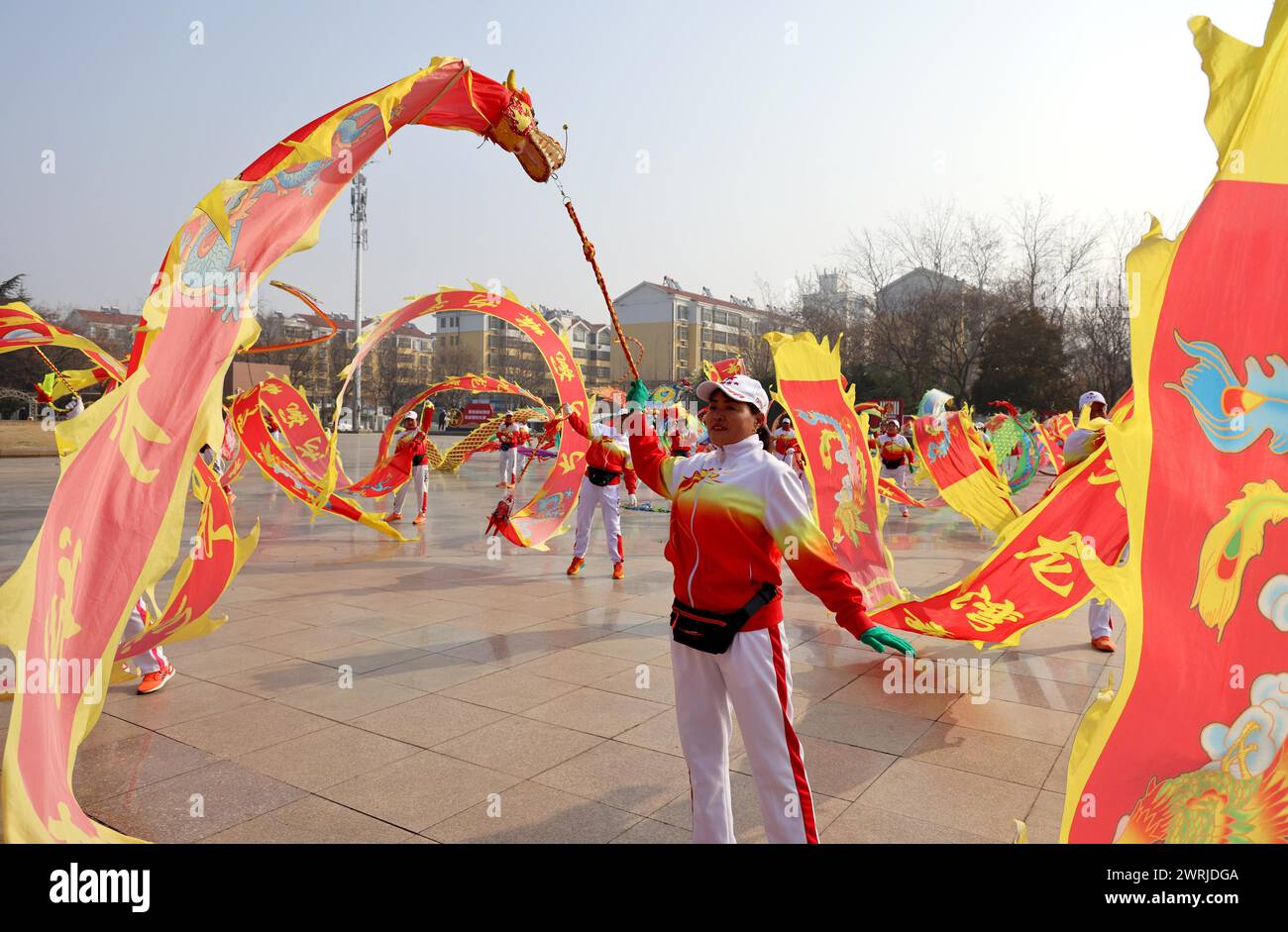 People dance with ribbon dragon to celebrate the Longtaitou Festival in Zaozhuang City, east ...