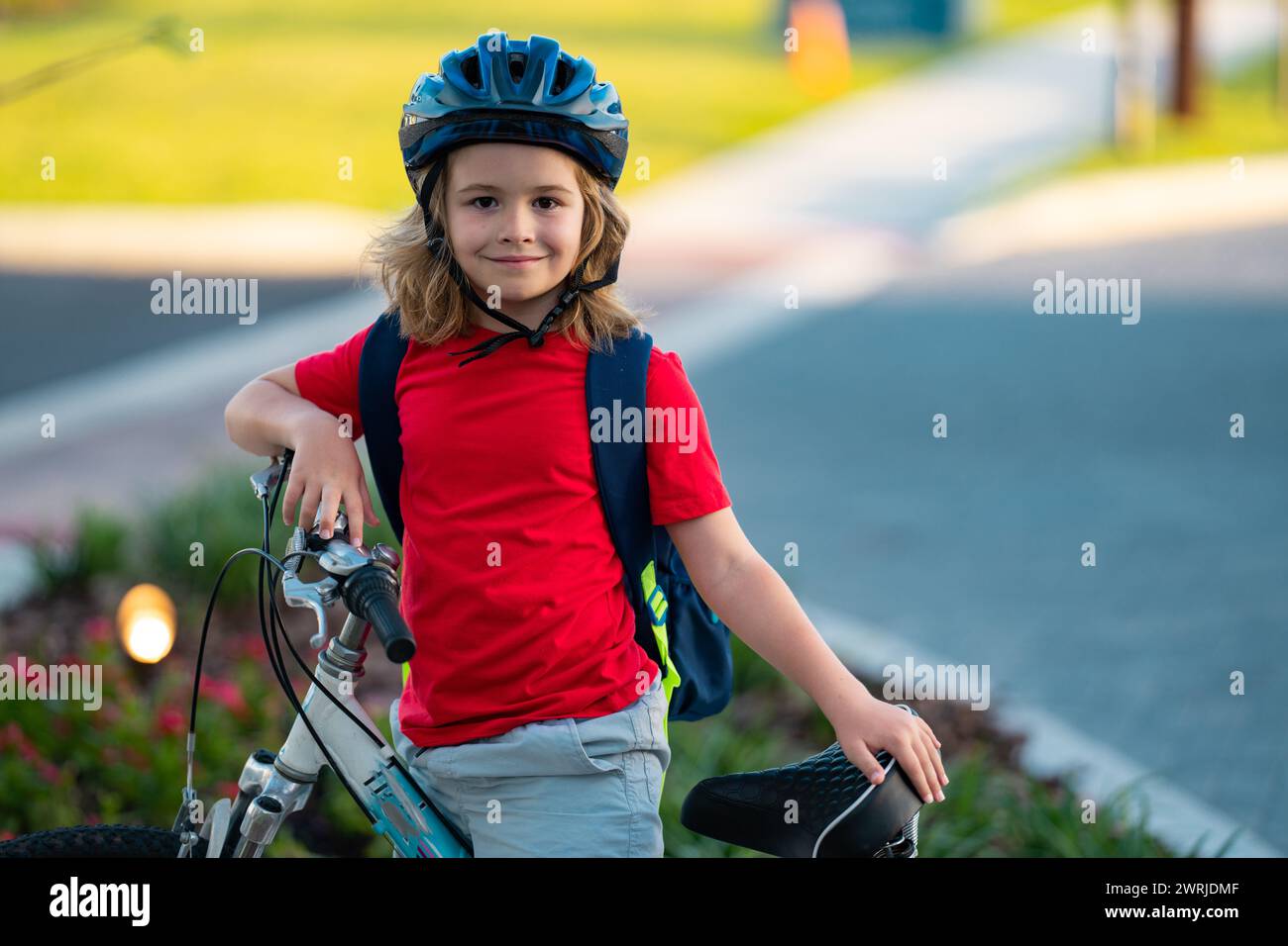Little kid boy riding a bike in summer park. Child drive a bike on a ...