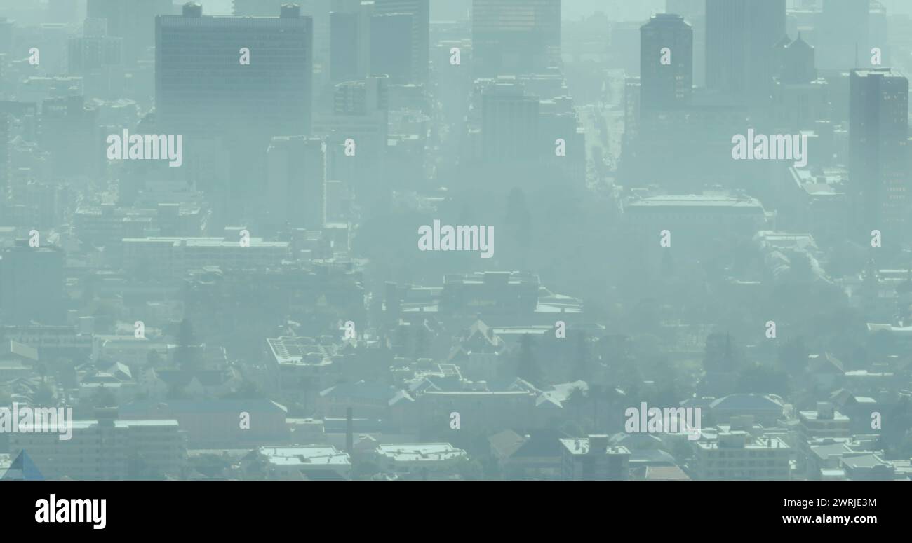 A cityscape is obscured by a thick layer of smog, signaling pollution ...
