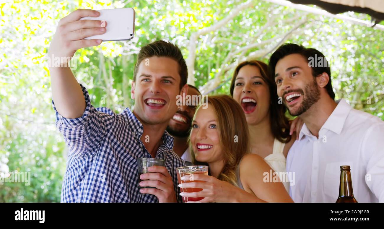 Emoji icons fly as diverse friends take a selfie at a party in 4k Stock ...