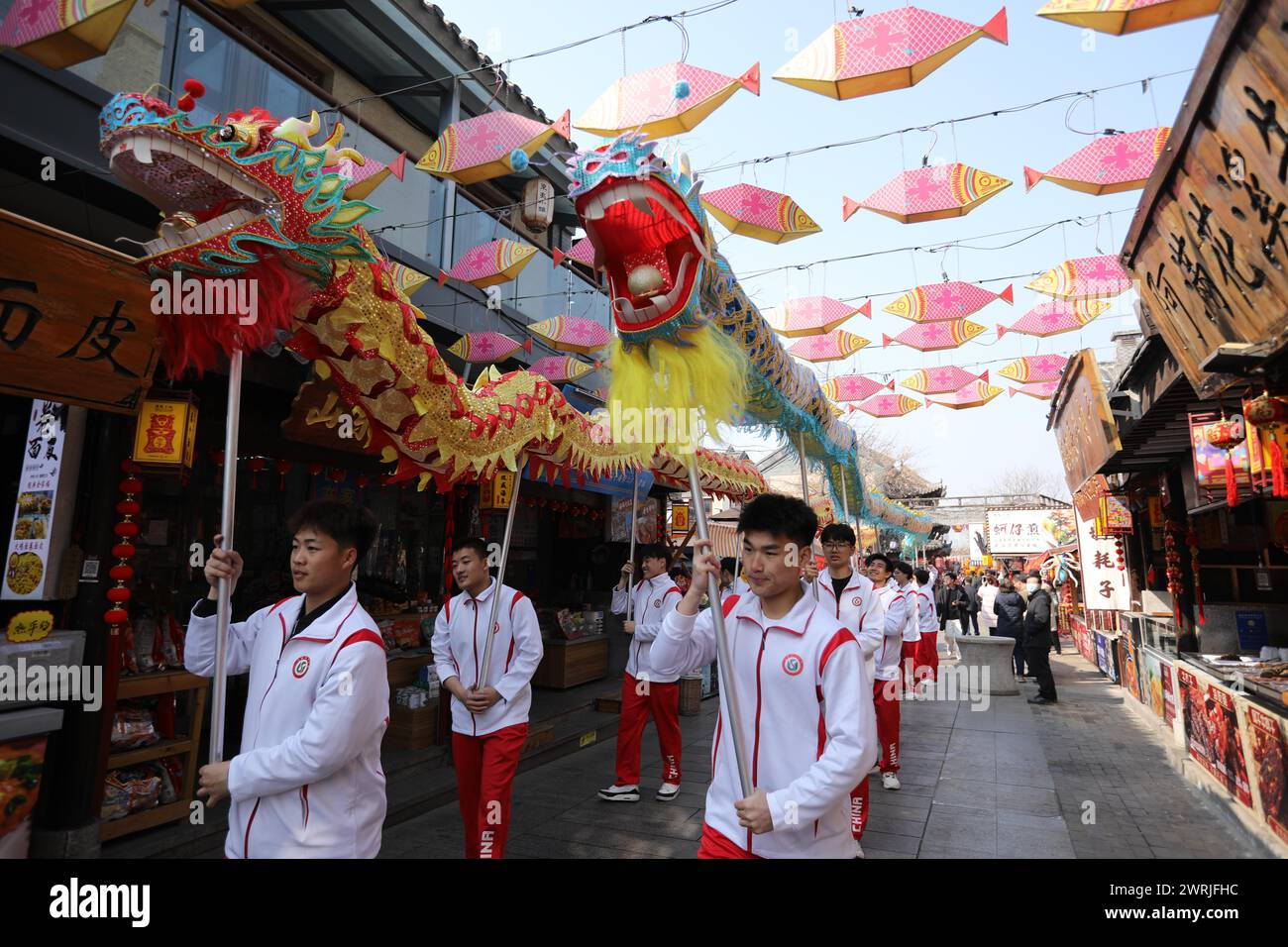 People participate in dragon dance to celebrate the Longtaitou Festival in Rizhao City, east ...