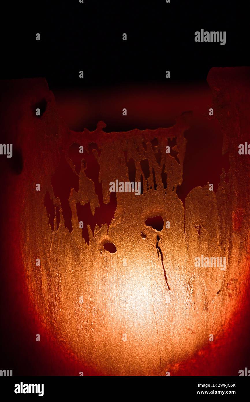 Handmade red color wax candle lit and fire indoor Stock Photo - Alamy