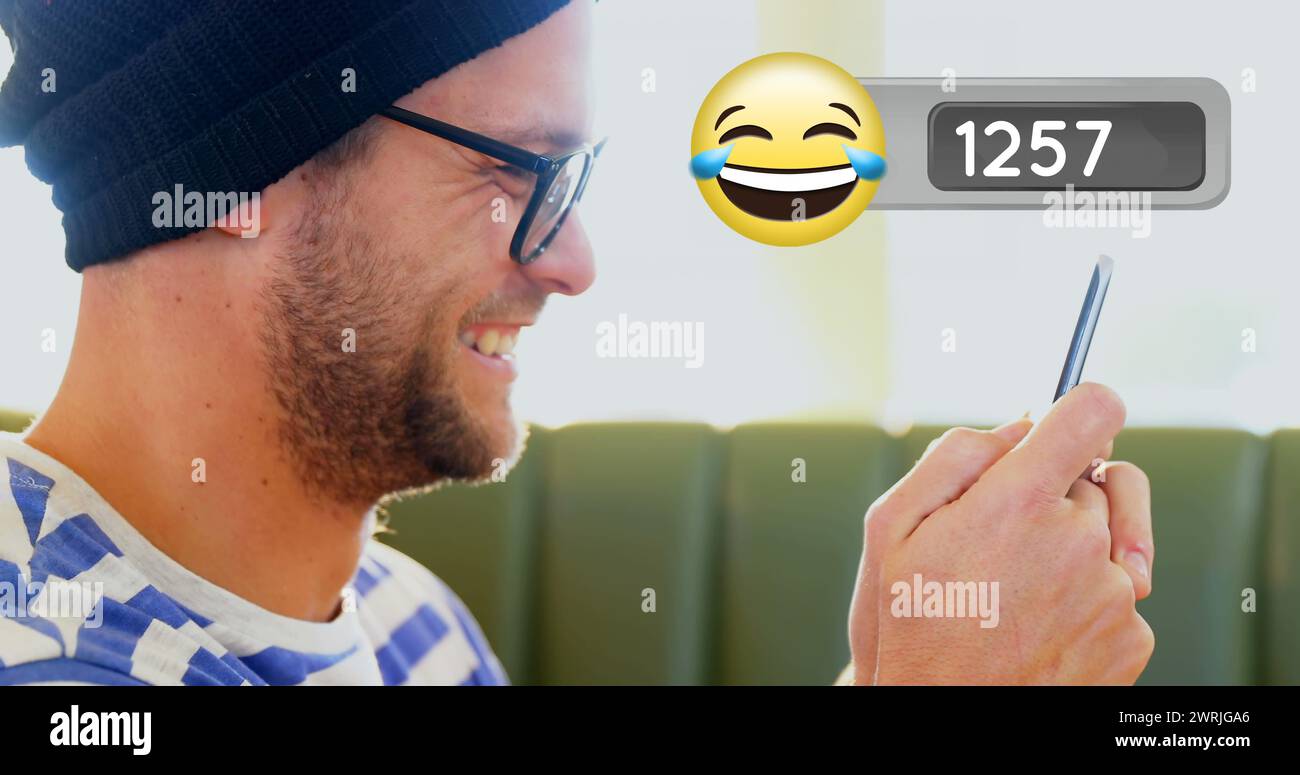 Close up side view of handsome Caucasian man laughing while typing on ...