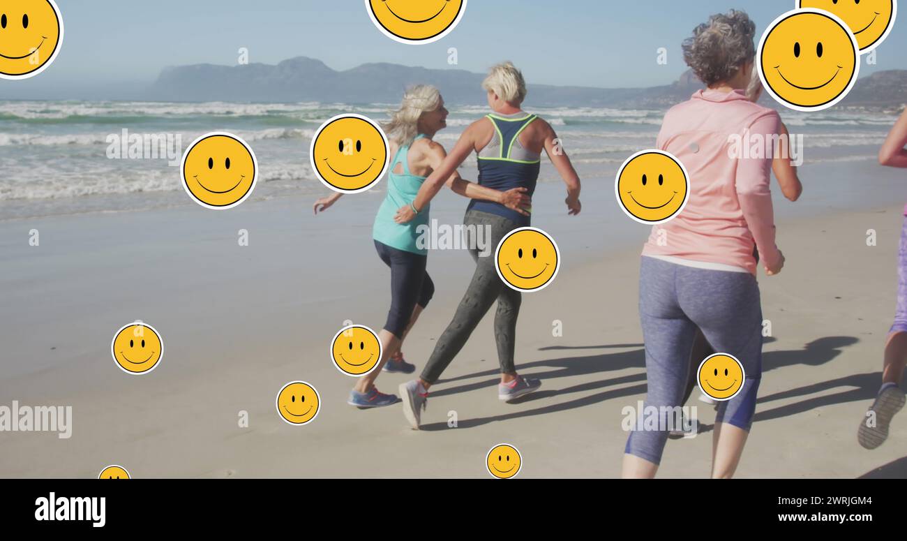 Image of smiley face symbols, over women running on beach Stock Photo ...