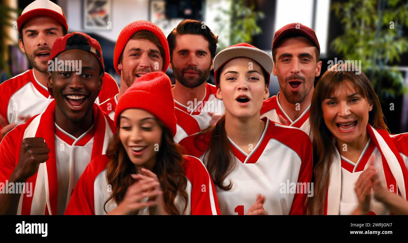 Front view of sports fans wearing white and red jerseys cheering for ...