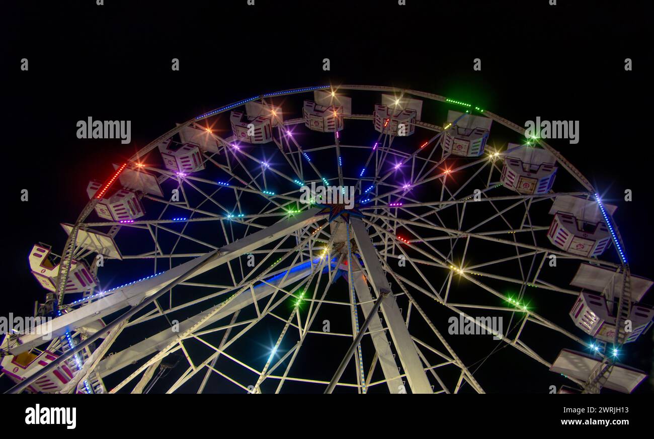A Mexican fair with rides and lights at night, with space for text ...