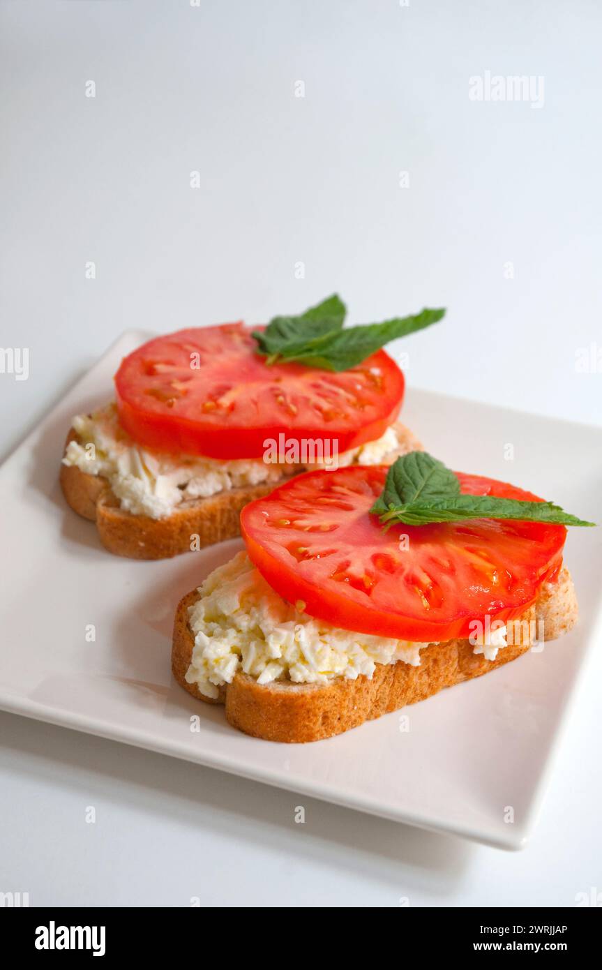Sliced tomato and cottage cheese on toast. Close view Stock Photo - Alamy