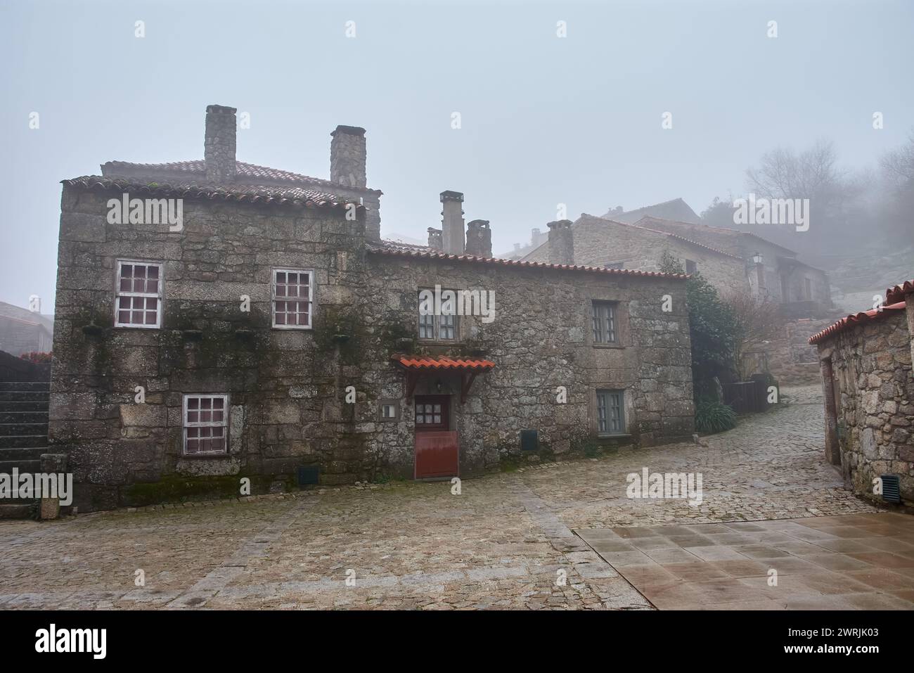 Walk through the fog through the alleys of the historic village of ...