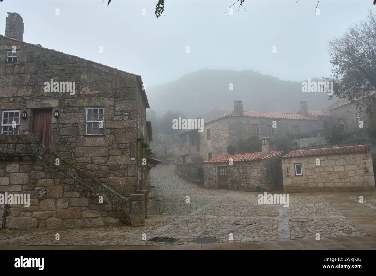 Walk through the fog through the alleys of the historic village of ...