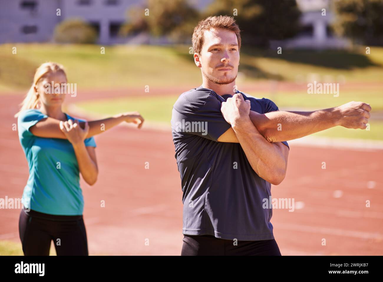 Fitness, arms and couple stretching in stadium for race, marathon or ...