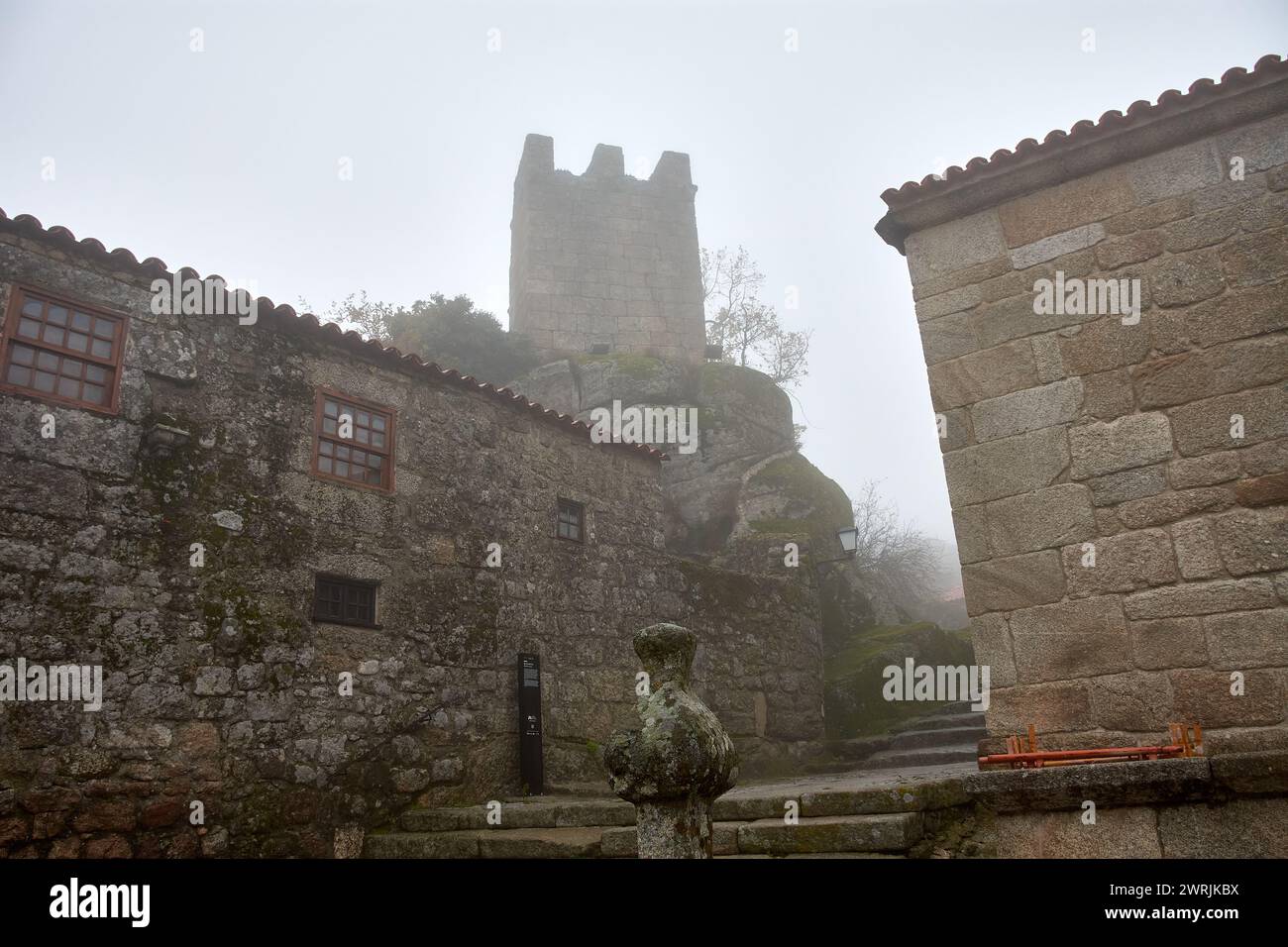 Walk through the fog through the alleys of the historic village of ...