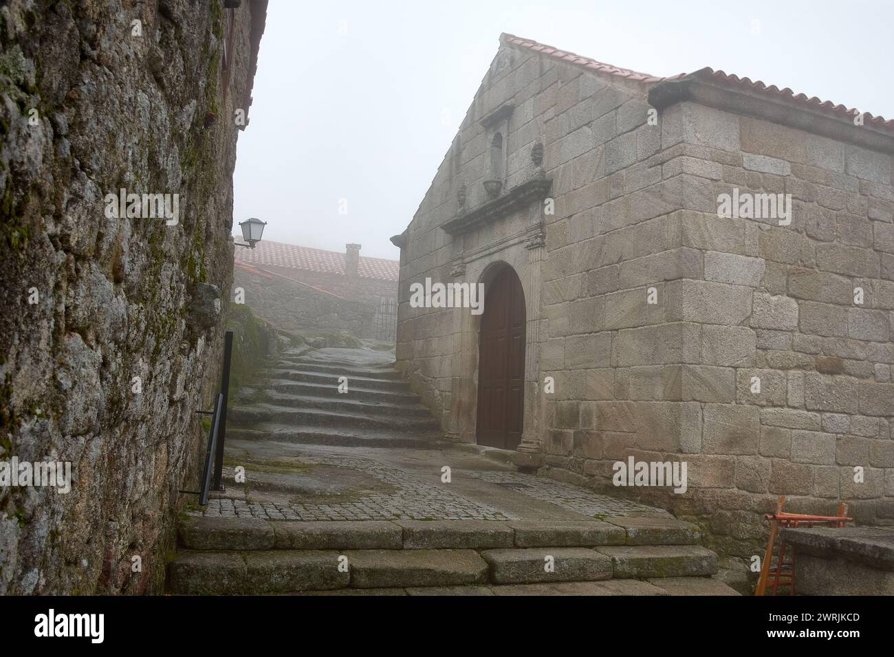 Walk through the fog through the alleys of the historic village of ...