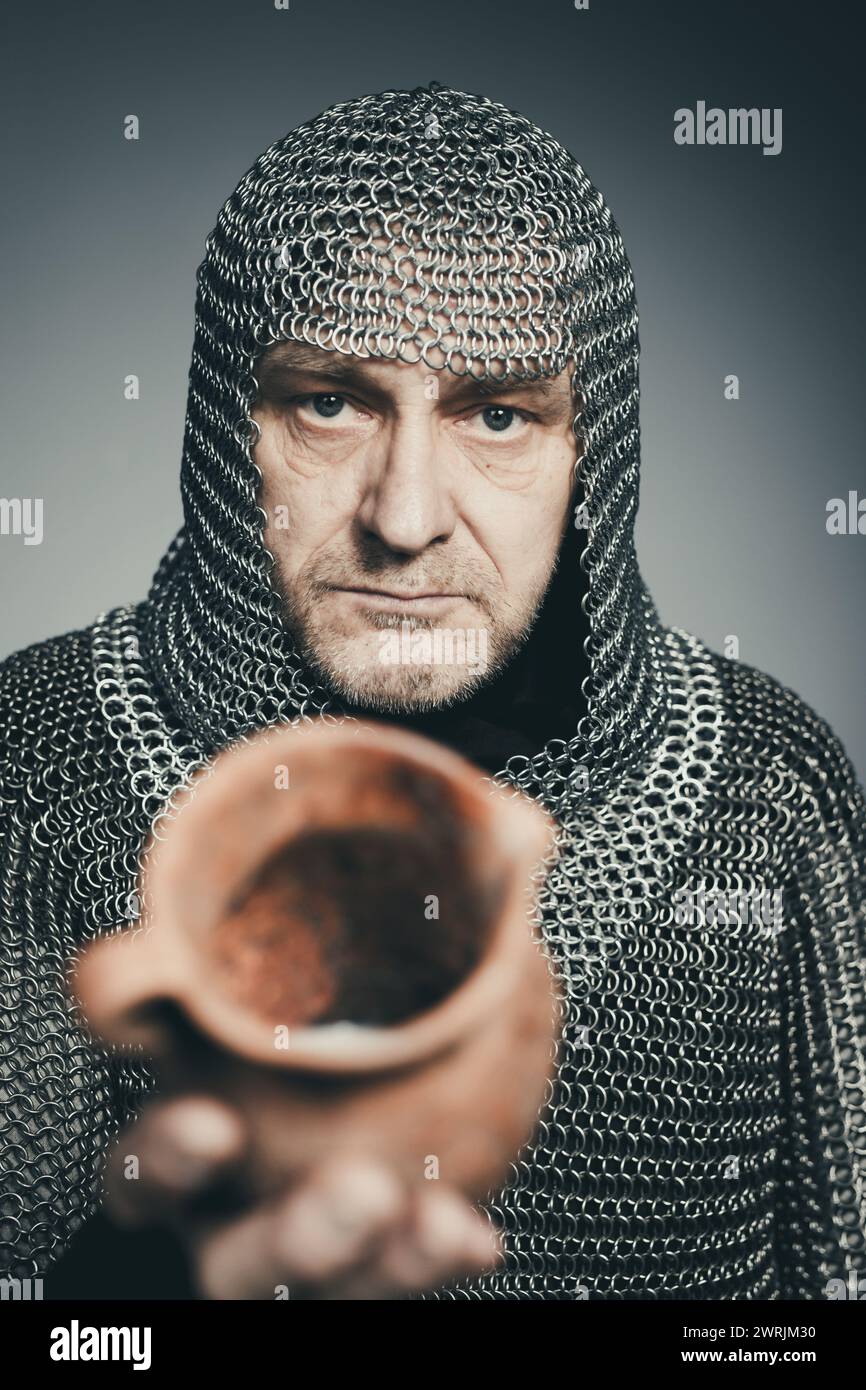 Medieval infantry armed man dressed in chain armor holding clay jug ... Medieval infantry armed man dressed in chain armor holding clay jug ...
