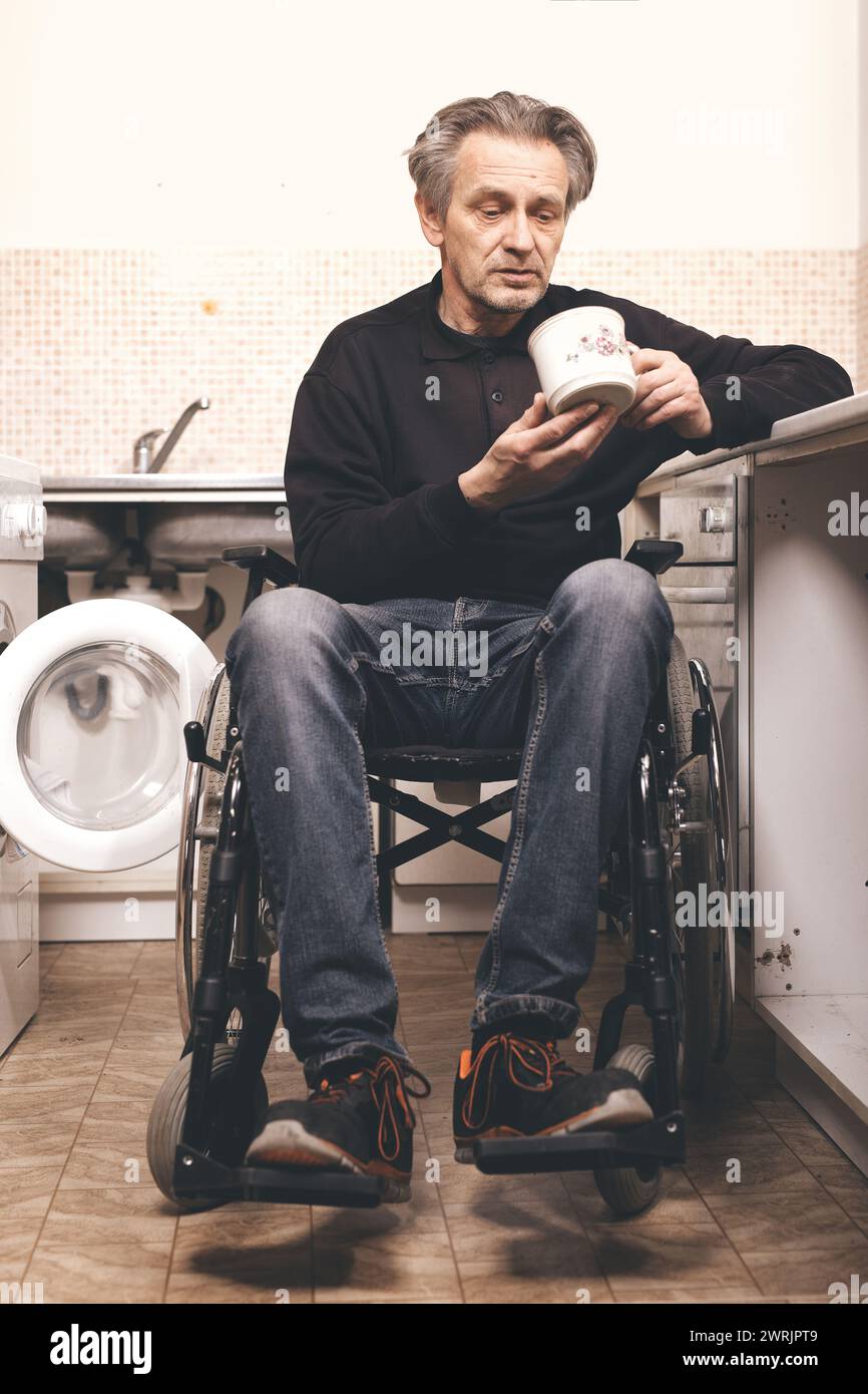 Old disabled man on wheel chair in his poor apartment Stock Photo - Alamy