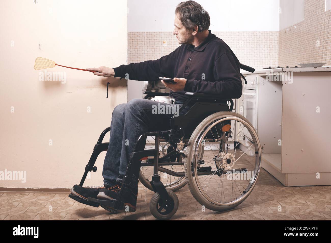 Old disabled man on wheel chair in his poor apartment Stock Photo - Alamy