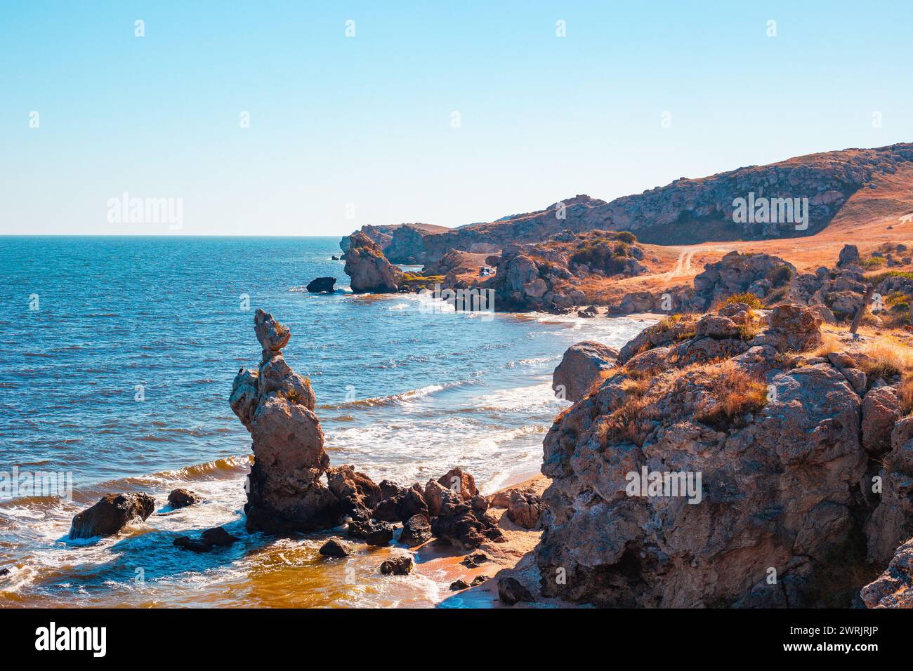 Seascape. Bizarre rocks on the seashore on a sunny summer day. General ...