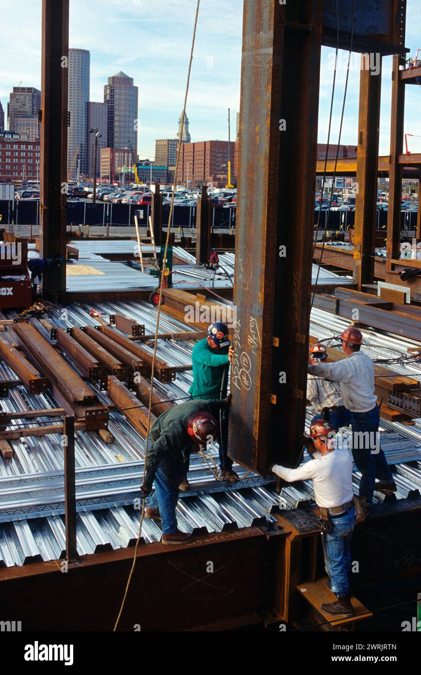 iron workers placing piece of iron to build building in Boston ...