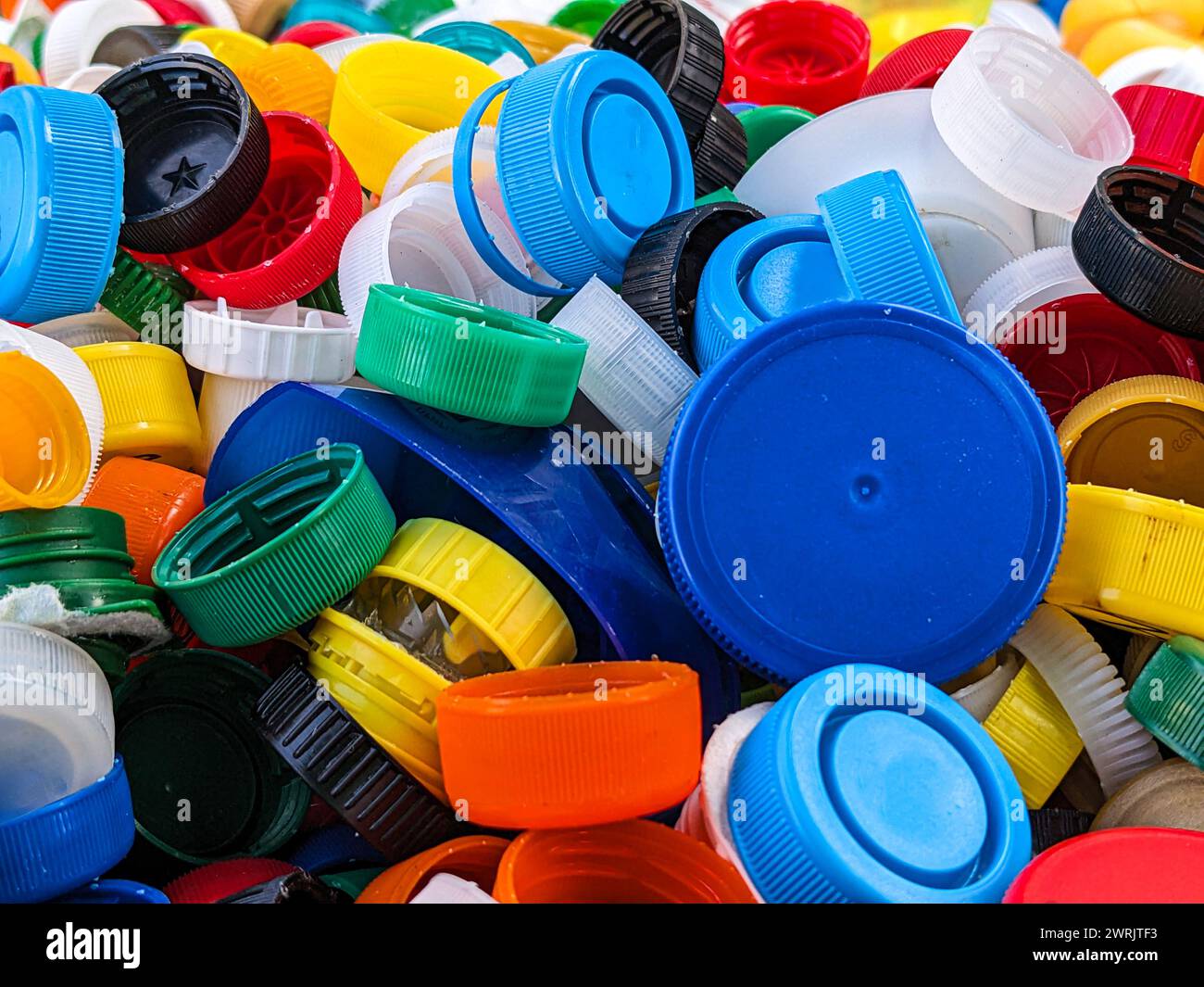 Lots of different plastic bottle caps. Garbage sorting Stock Photo - Alamy