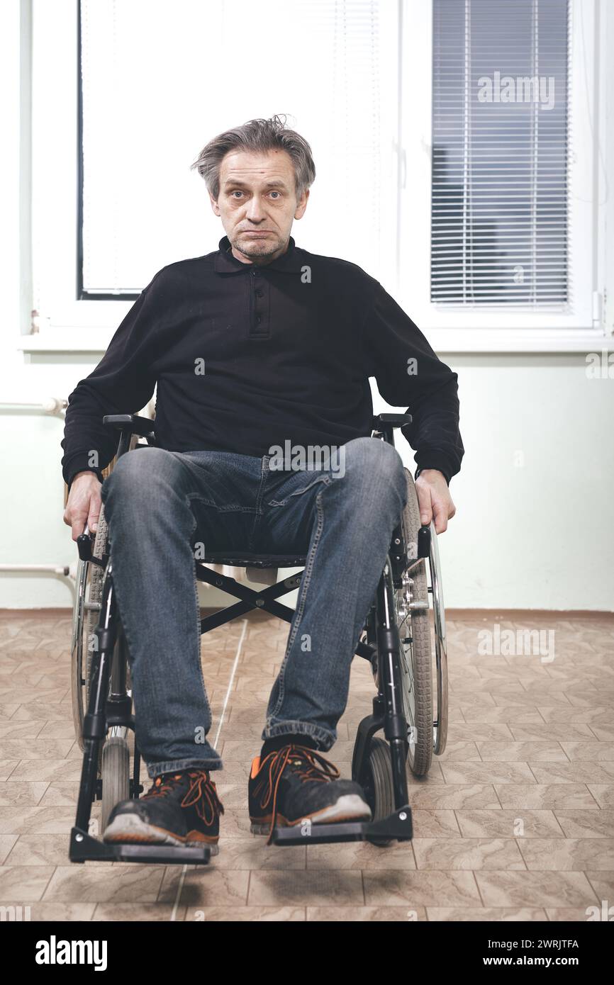 Old disabled man on wheel chair in his poor apartment Stock Photo - Alamy