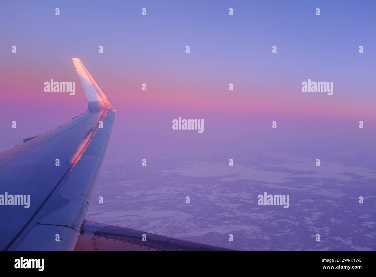 Airplane flying over a snowy landscape in Rovaniemi, Finland on a ...