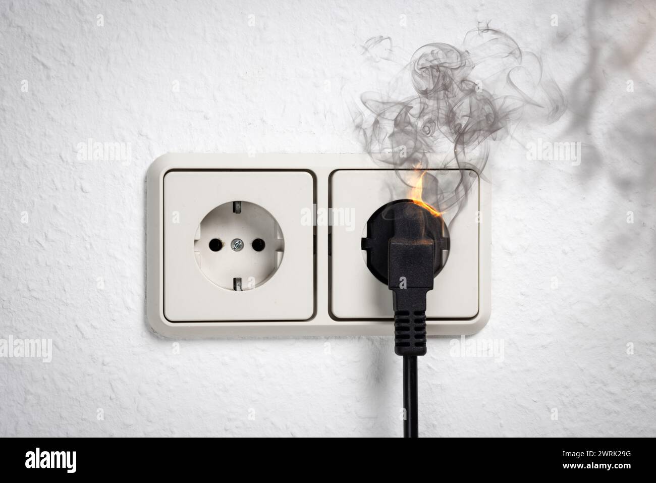 Electric Plug and Socket with Smoke and Fire Stock Photo - Alamy
