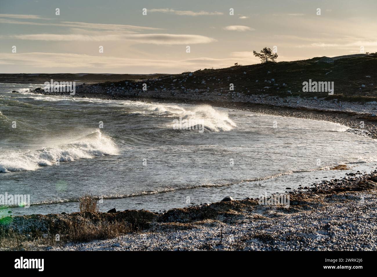 STORM WAVES ROLL INTO AN IDYLLIC REMOTE ISLAND BEACH, BALTIC SEA: Storm waves sweep across an ...