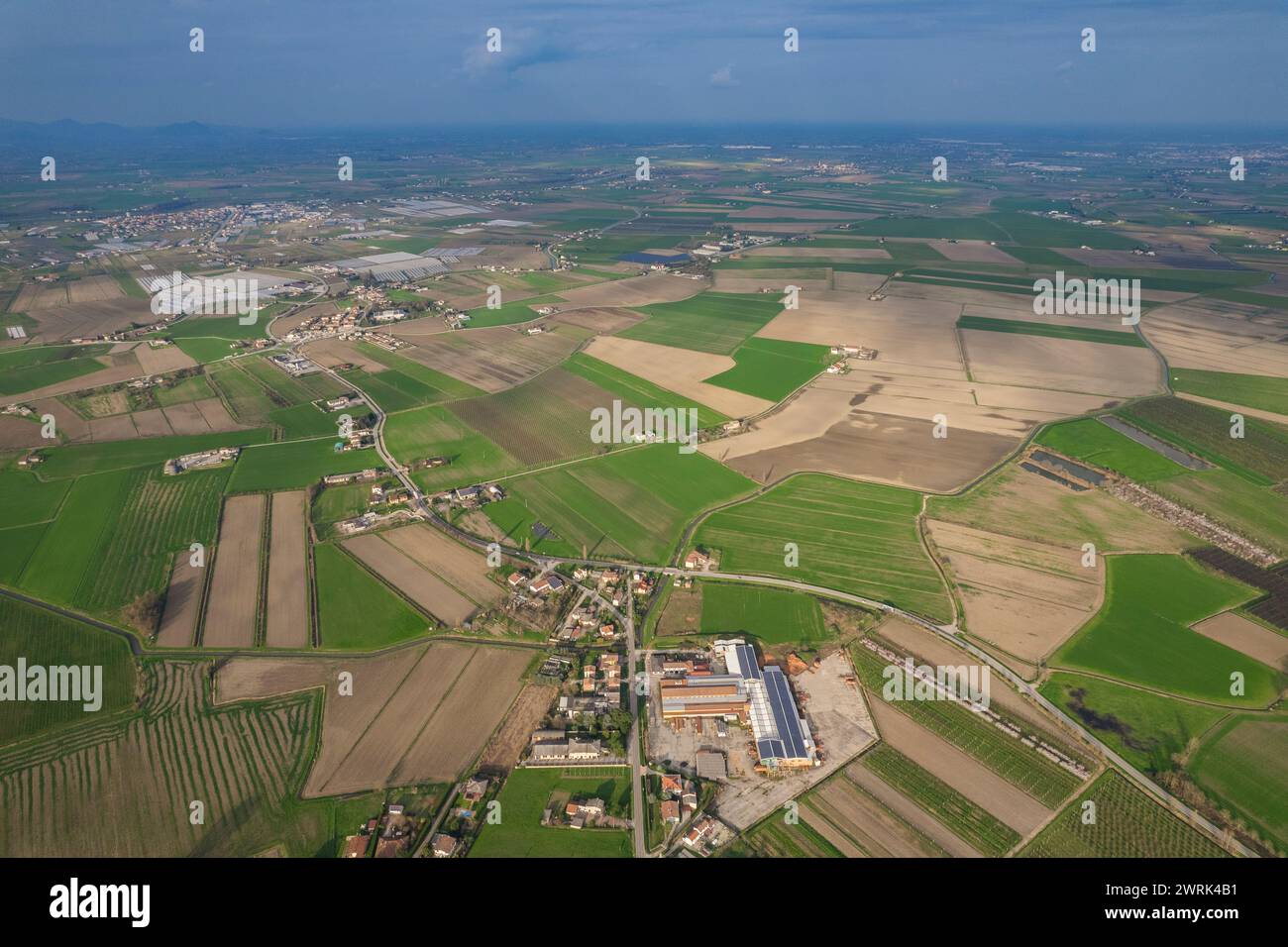 The aerial view showcases vast farmland in the Po Valley region. Fields ...