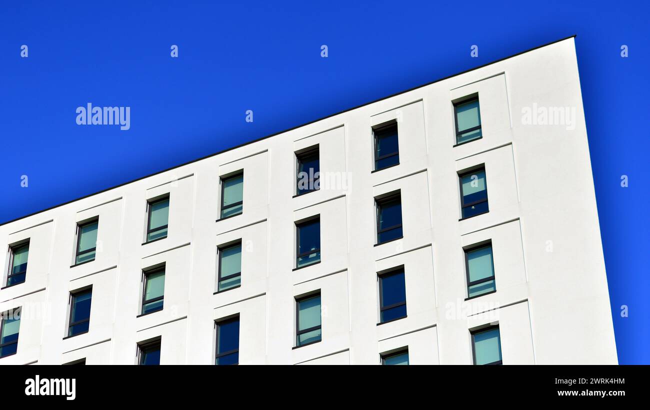 View of a white modern apartment building. Perfect symmetry with blue ...