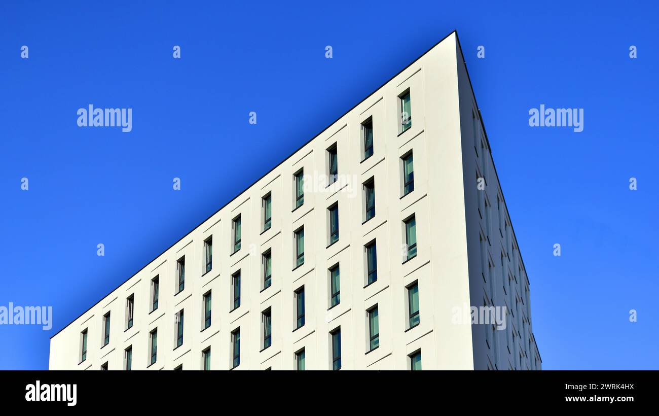View of a white modern apartment building. Perfect symmetry with blue ...