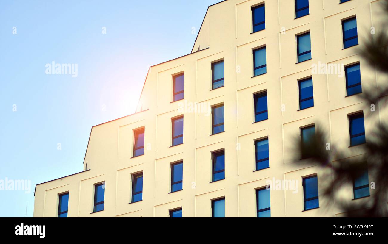View of a white modern apartment building. Perfect symmetry with blue ...