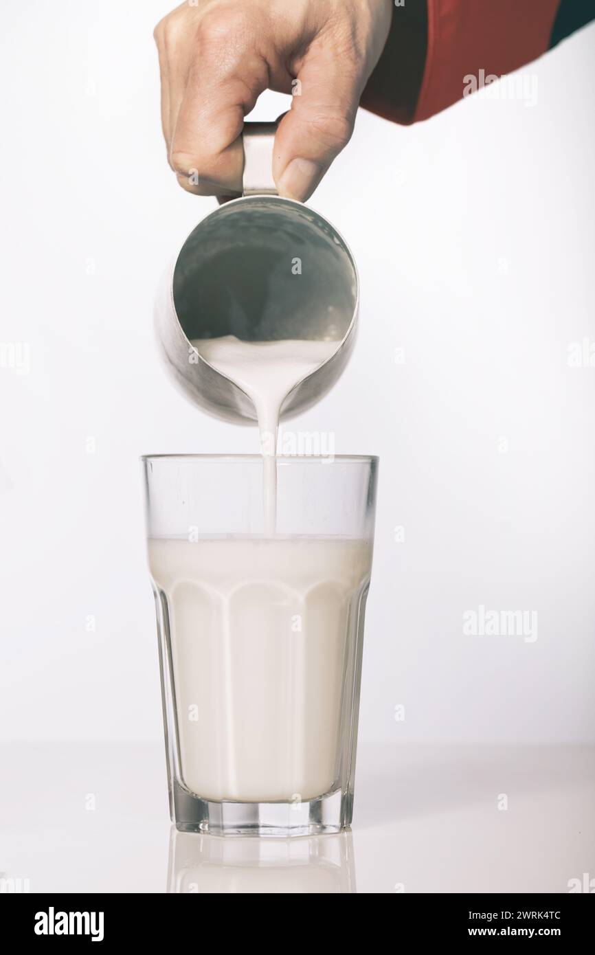 Preparing a caffe latte style hot drink from espresso and milk Stock ...