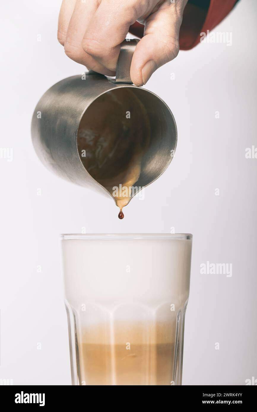 Preparing a caffe latte style hot drink from espresso and milk Stock Photo - Alamy