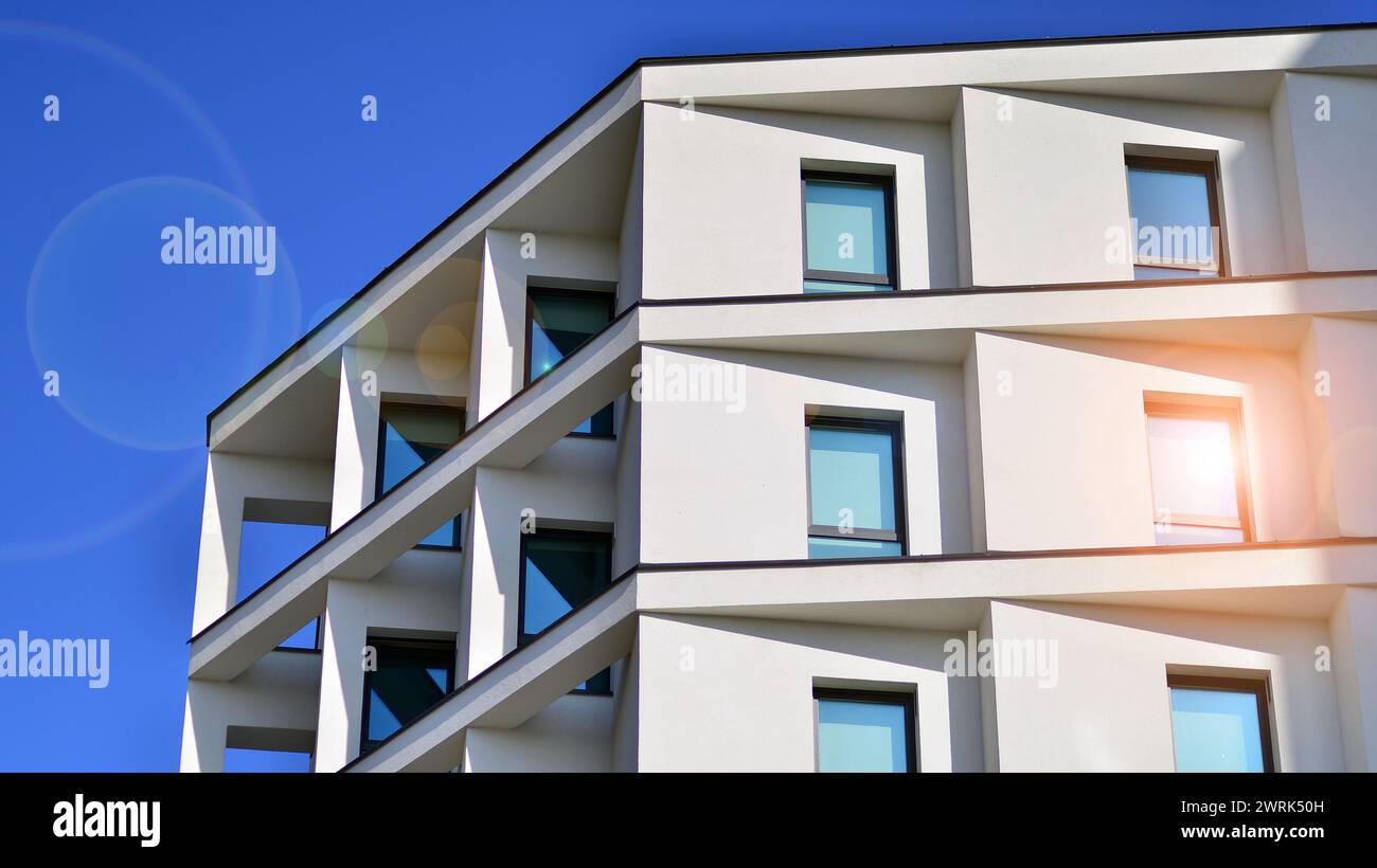 View of a white modern apartment building. Perfect symmetry with blue ...