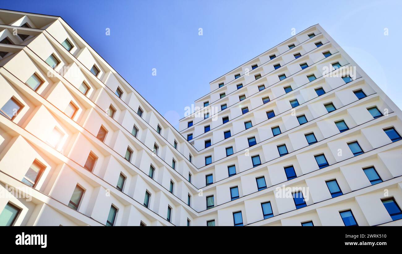 View of a white modern apartment building. Perfect symmetry with blue ...