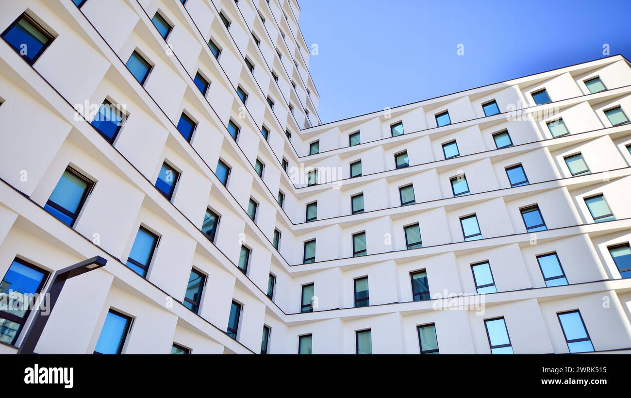 View of a white modern apartment building. Perfect symmetry with blue ...