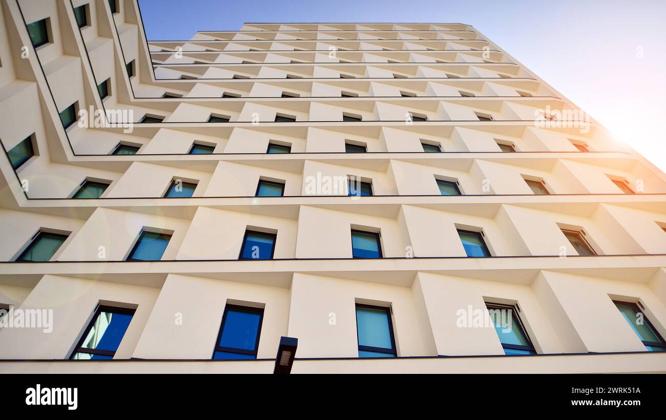 View of a white modern apartment building. Perfect symmetry with blue ...