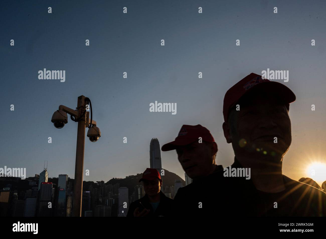 Surveillance cameras are seen as visitors walk along promenade next to ...