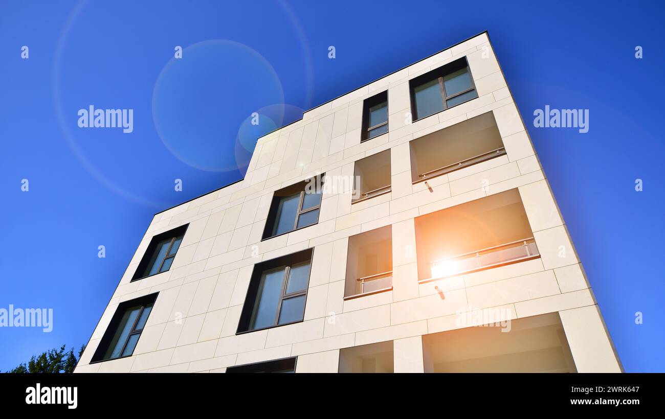 View of a white modern apartment building. Perfect symmetry with blue ...