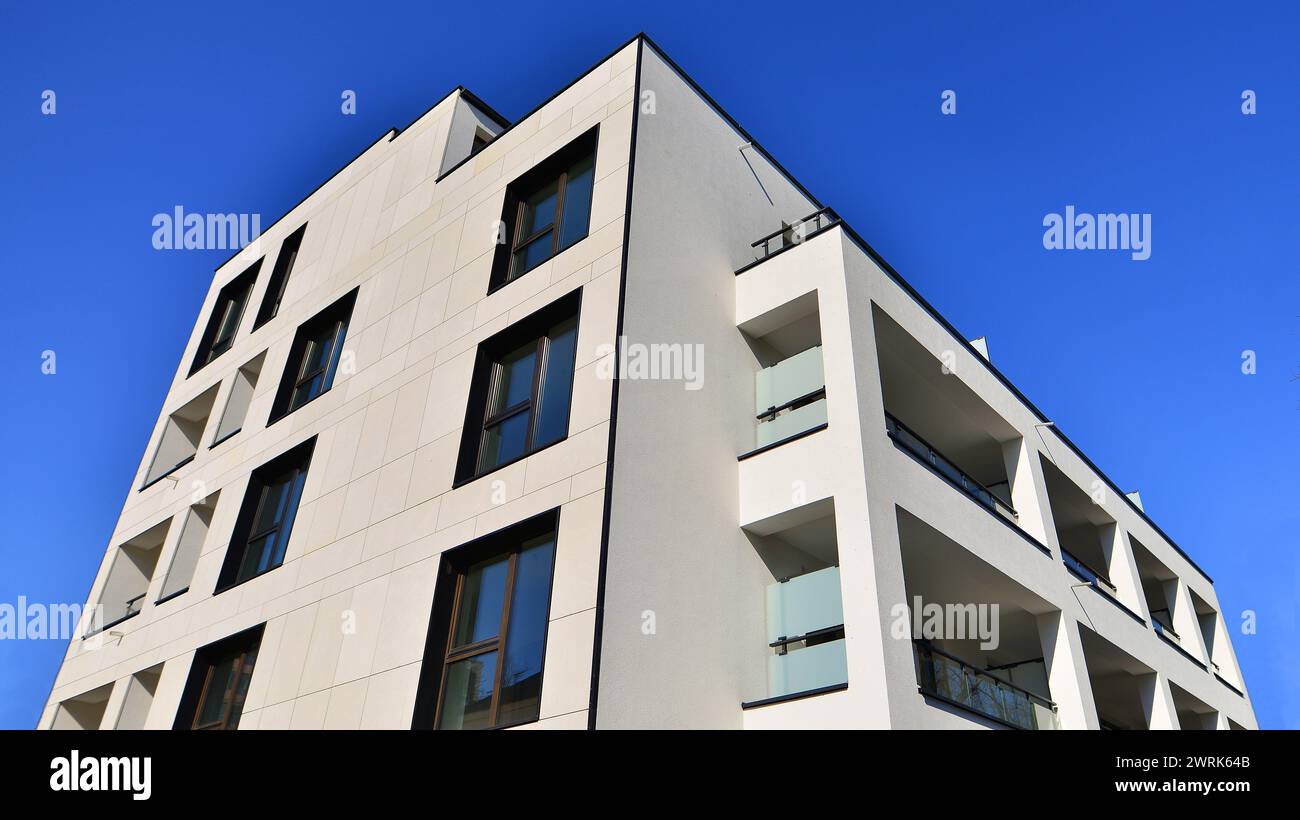 View of a white modern apartment building. Perfect symmetry with blue ...