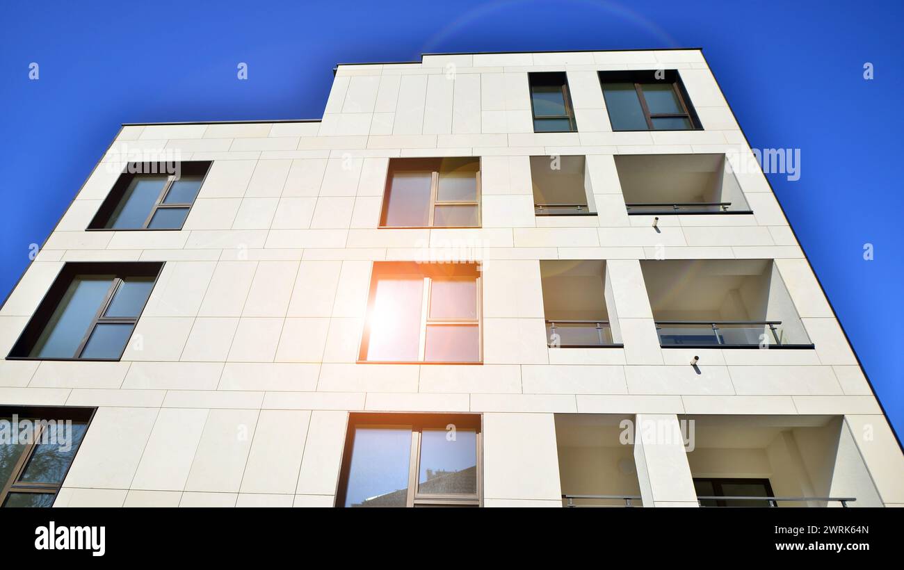 View of a white modern apartment building. Perfect symmetry with blue ...