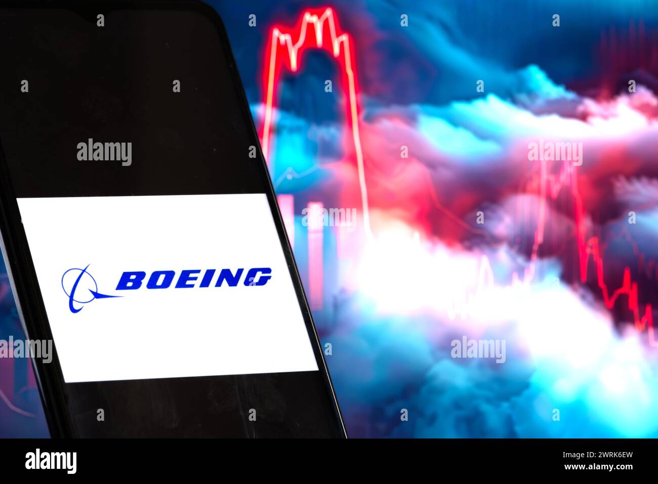 Logo of Boeing is sharp in the foreground, while the stock chart in the ...