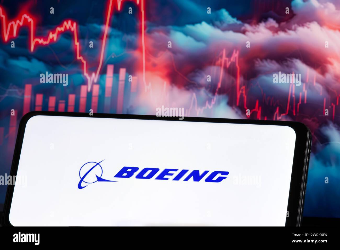 Logo of Boeing is sharp in the foreground, while the stock chart in the ...