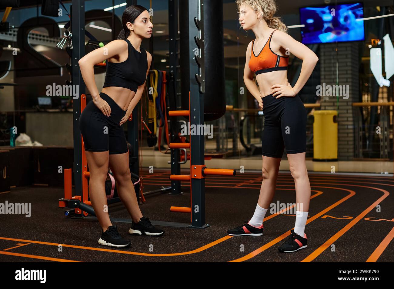 good looking female coach helping her blonde appealing client to ...